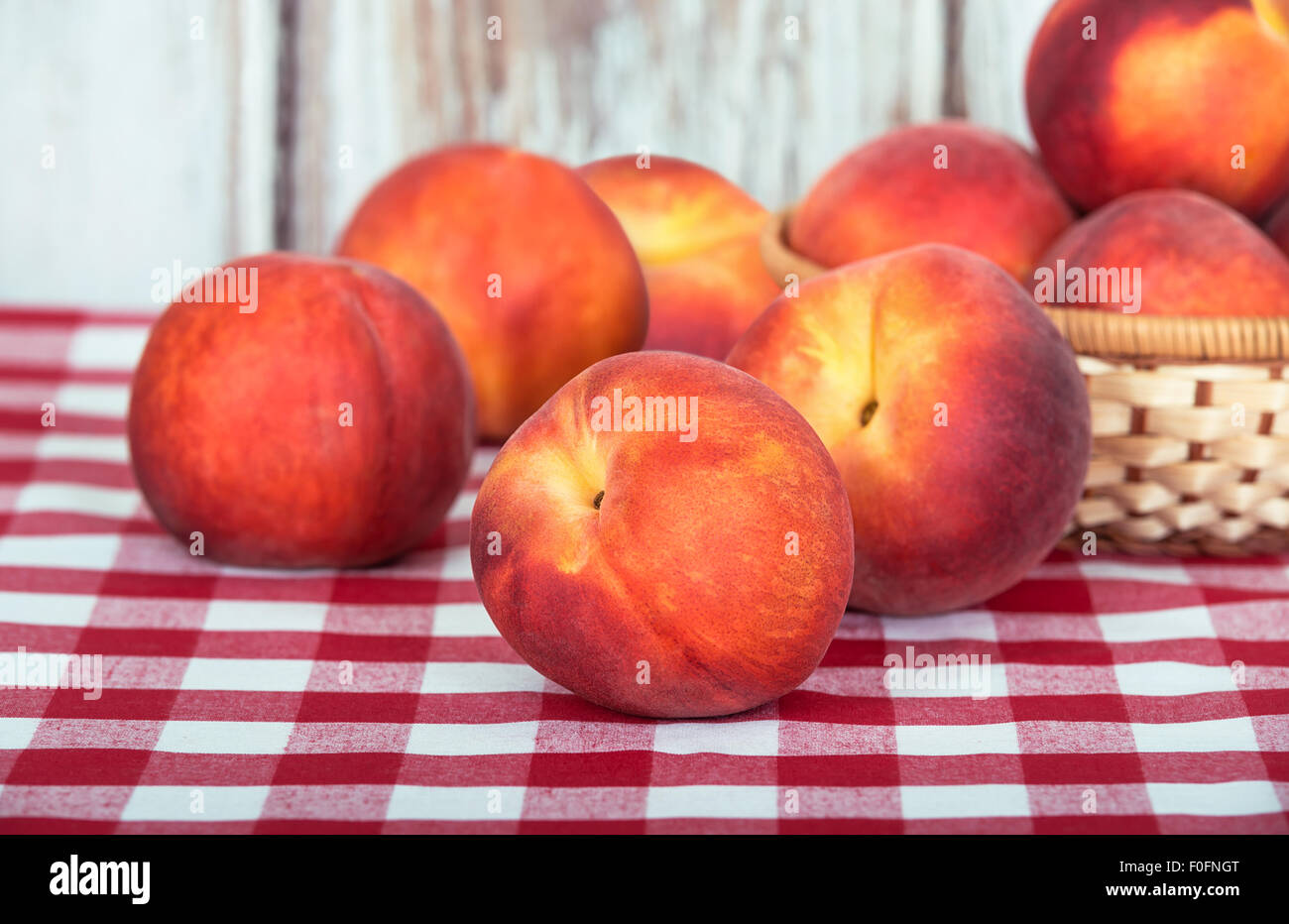 Closeup of fresh peach fruits on table Stock Photo - Alamy