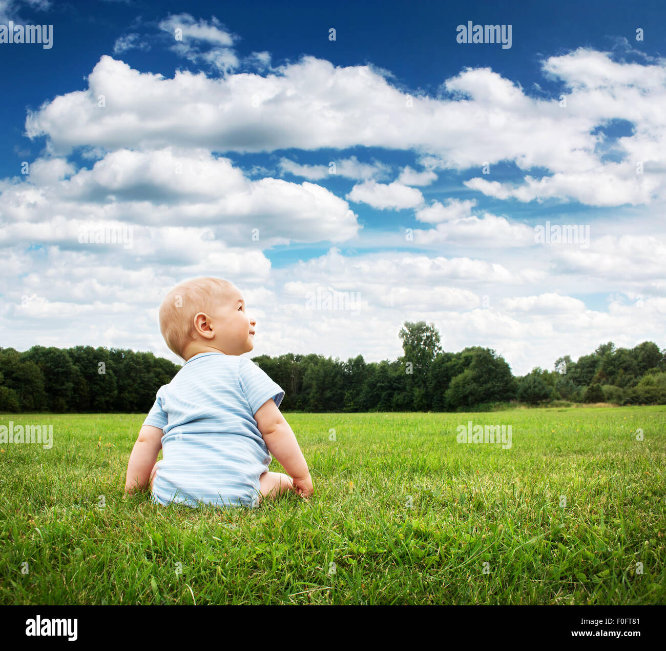 Little baby sitting on the grass Stock Photo - Alamy