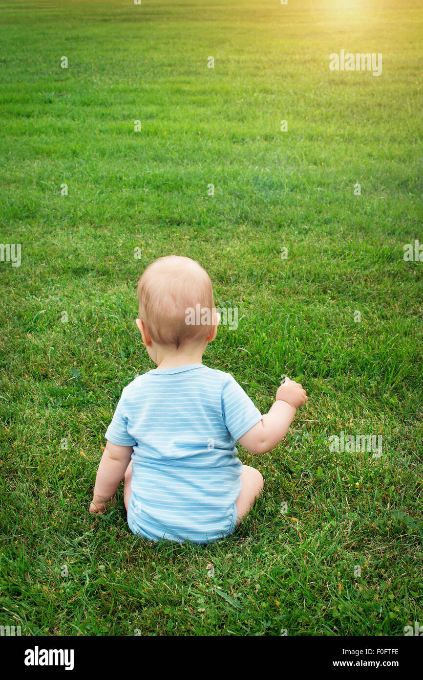 Little baby sitting on the grass Stock Photo - Alamy