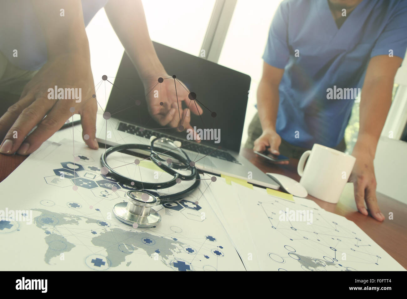 team doctor working with laptop computer in medical workspace office ...