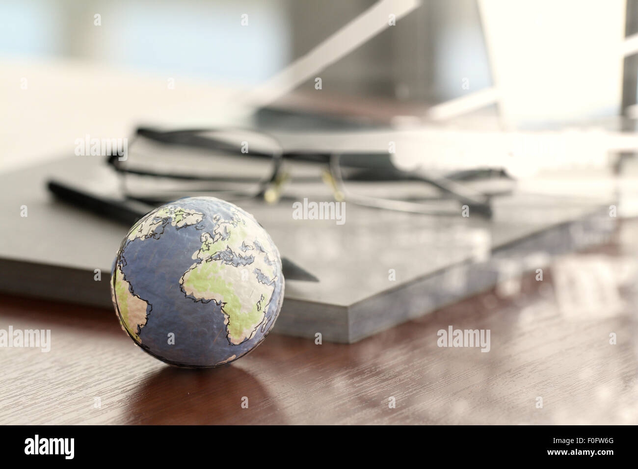 double exposure of hand drawn texture globe on wood table near note ...