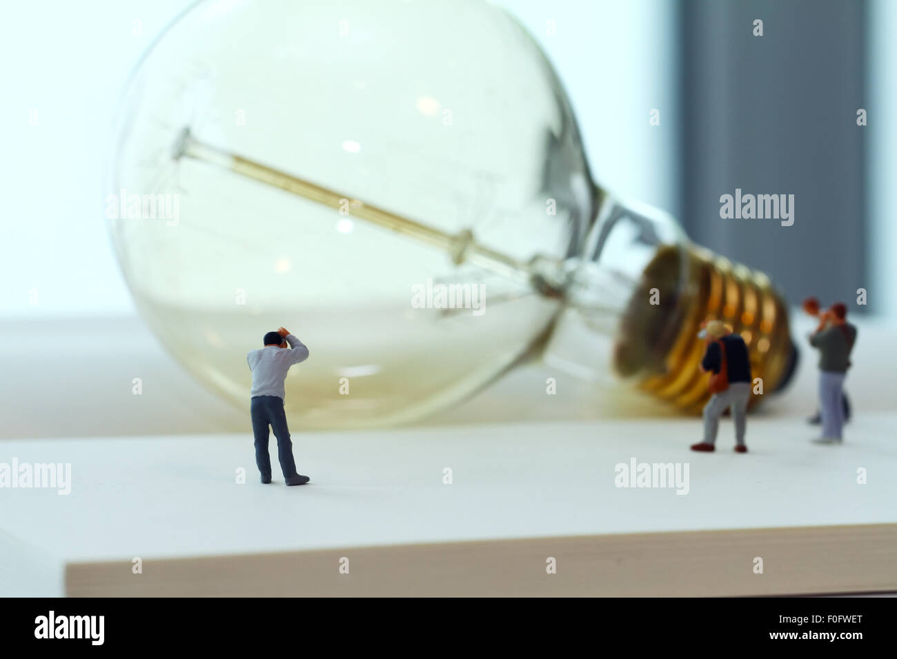 Creative idea concept - miniature photographer with vintage light bulb ...