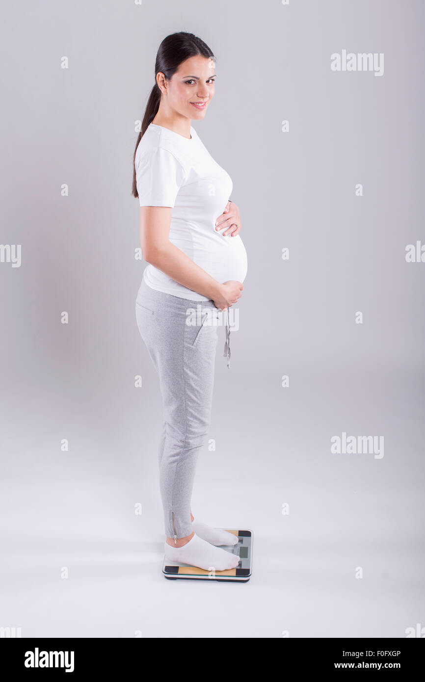 Young pregnant woman checking weight Stock Photo - Alamy