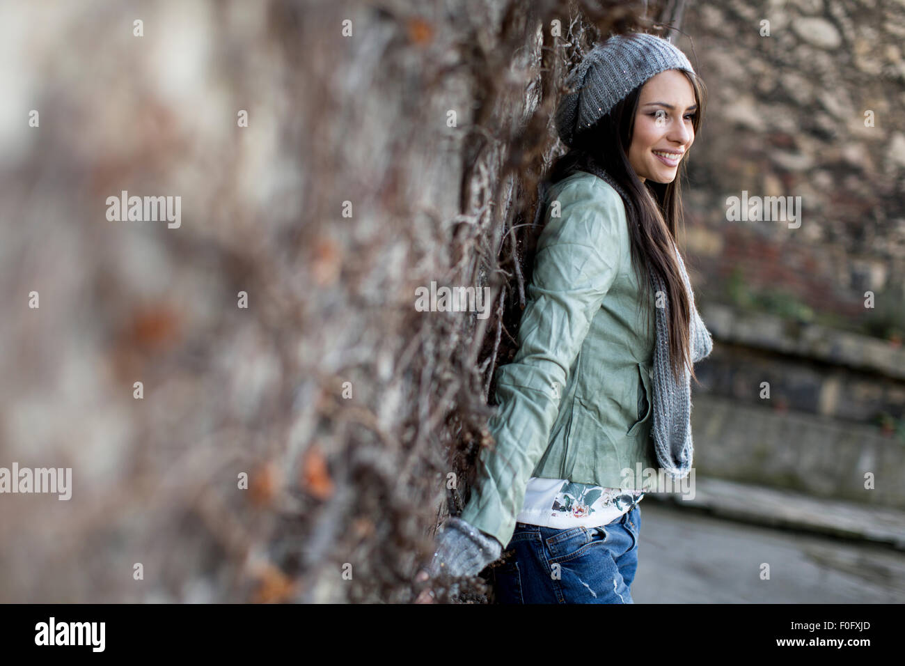 Young woman by the wall at autumn Stock Photo - Alamy