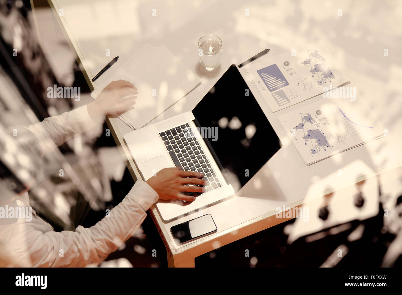 Double exposure of businessman hand working with new modern computer ...