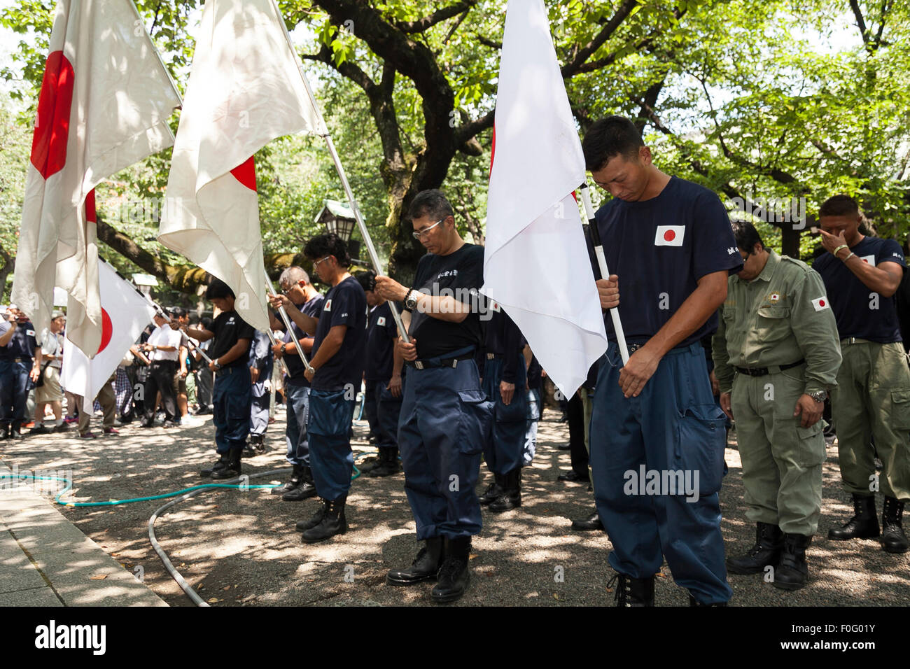 Tokyo, Japan. 15th Aug, 2015. Members of the nationalist group bow to ...