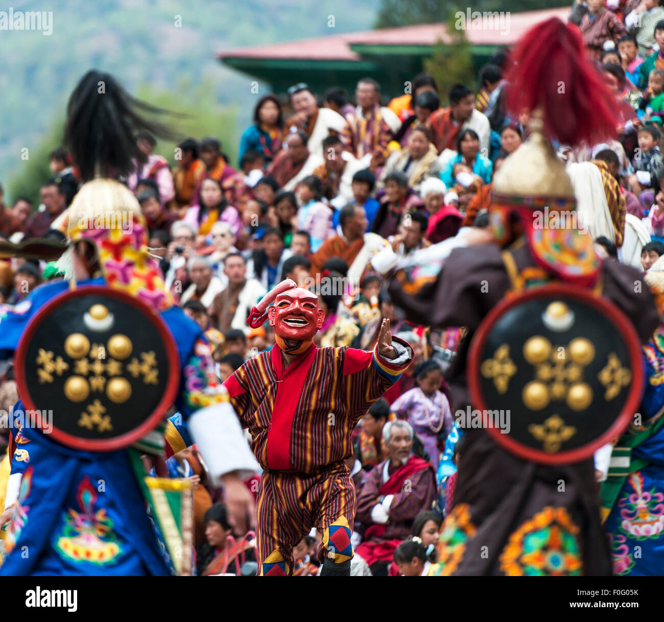 Atsara figure dancing amongst other dancers Paro religious festival ...