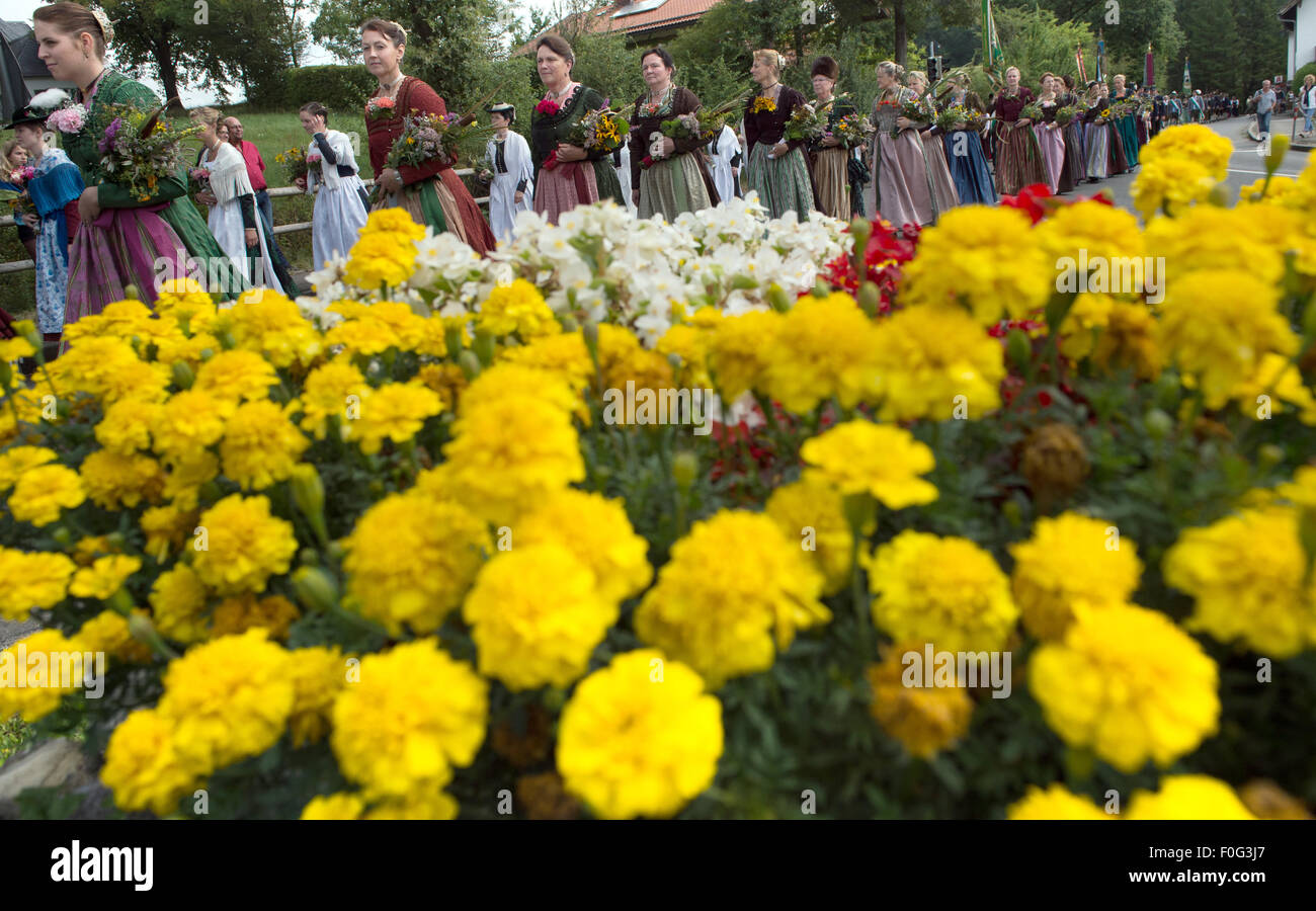 Kochel am See, Germany. 15th August, 2015. Girls traditional garb carry ...
