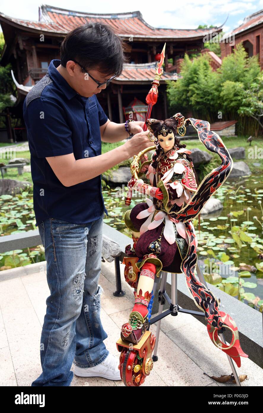 Taipei's Taiwan. 15th Aug, 2015. A fan of glove puppetry sets a muppet ...
