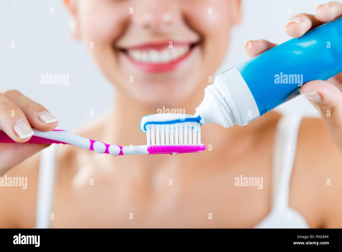 Portrait of beautiful young woman picking his teeth Stock Photo - Alamy