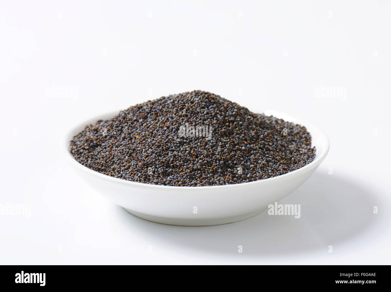 Whole poppy seeds on plate Stock Photo - Alamy