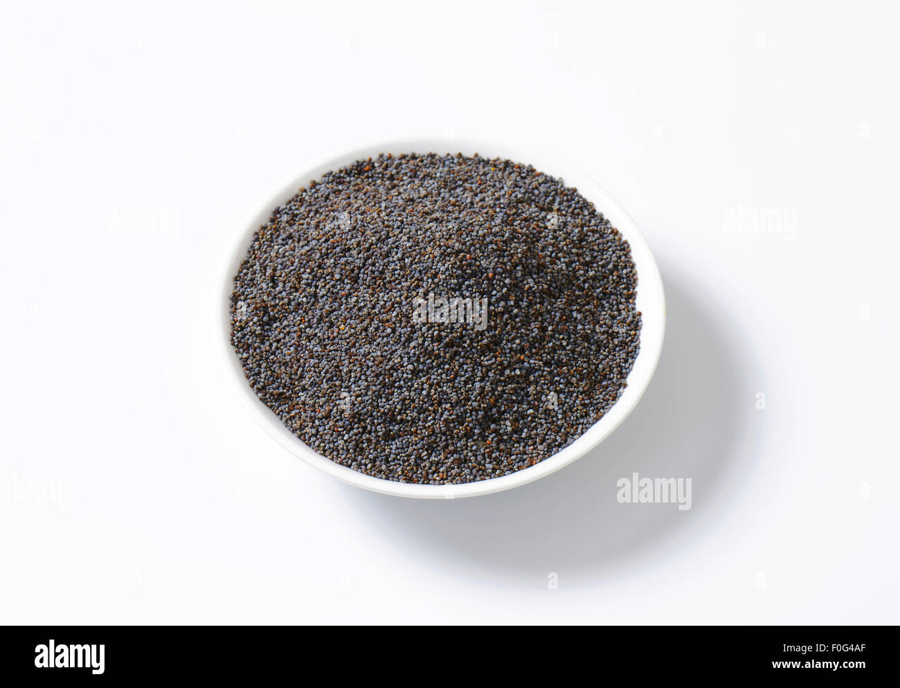 Whole poppy seeds on plate Stock Photo - Alamy