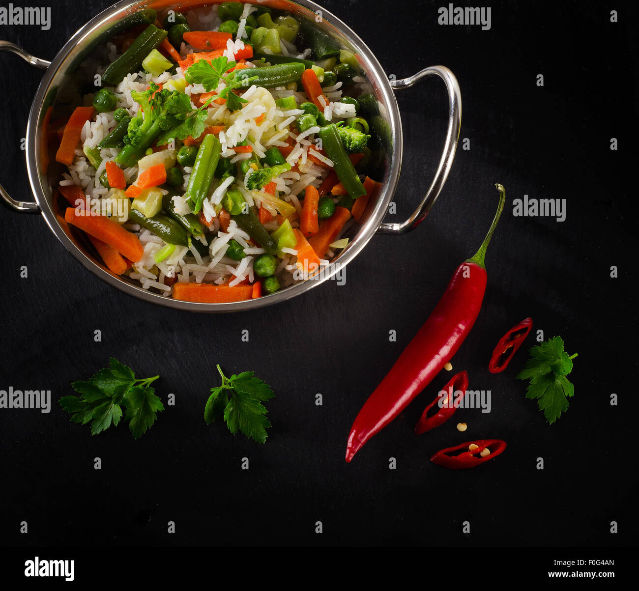 Rice and vegetables on black background. Selective focus Stock Photo ...