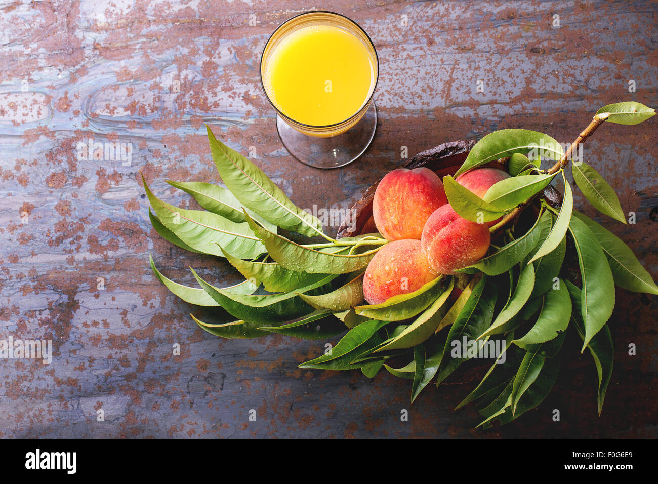 Peaches on branch and juice Stock Photo - Alamy