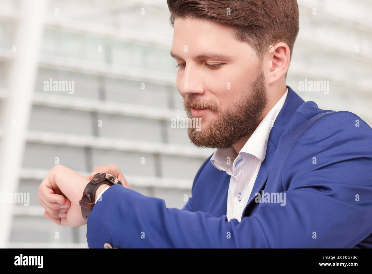 Handsome guy with beard checking time Stock Photo - Alamy