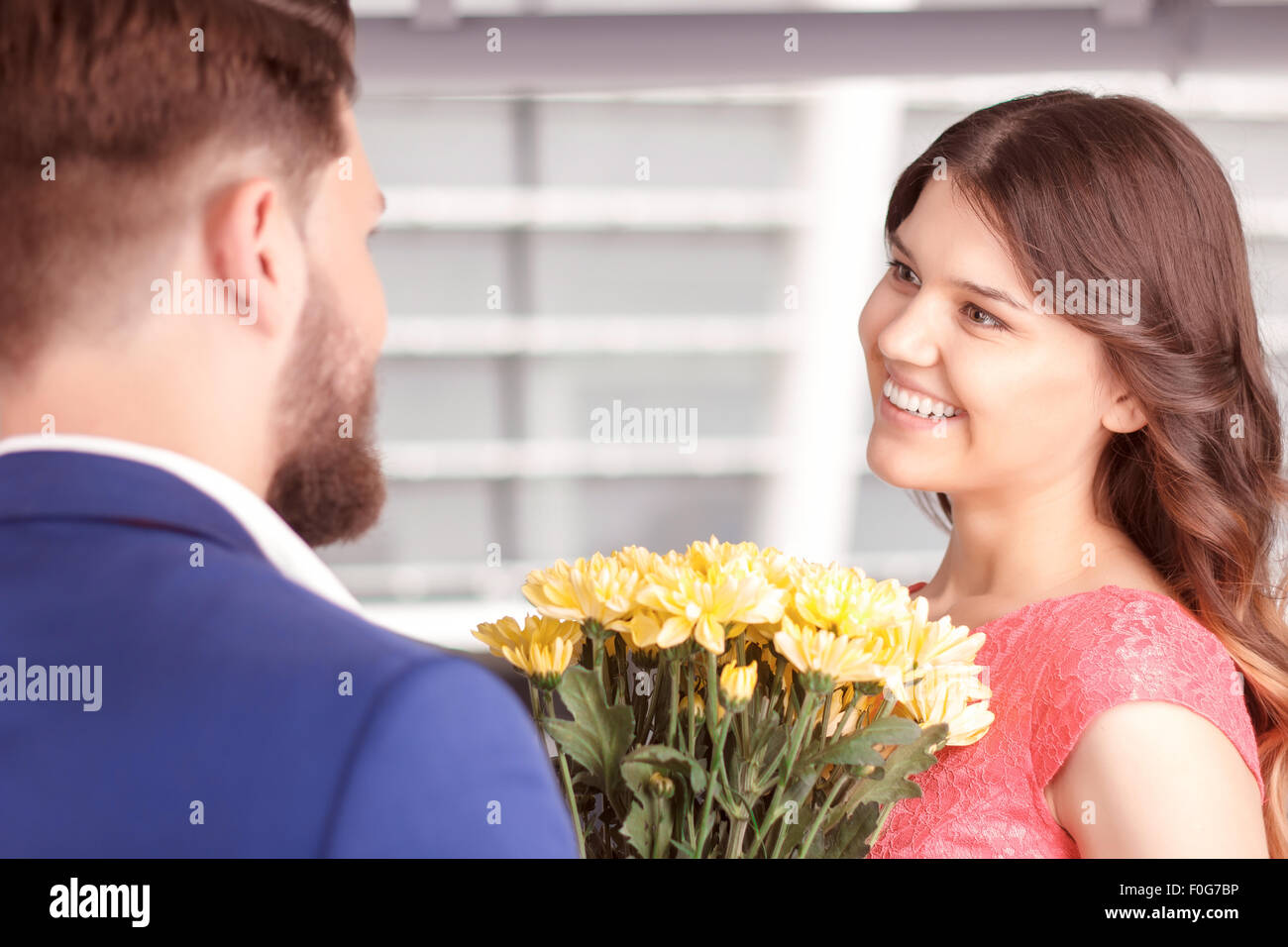 Man presenting flowers to his girlfriend Stock Photo - Alamy