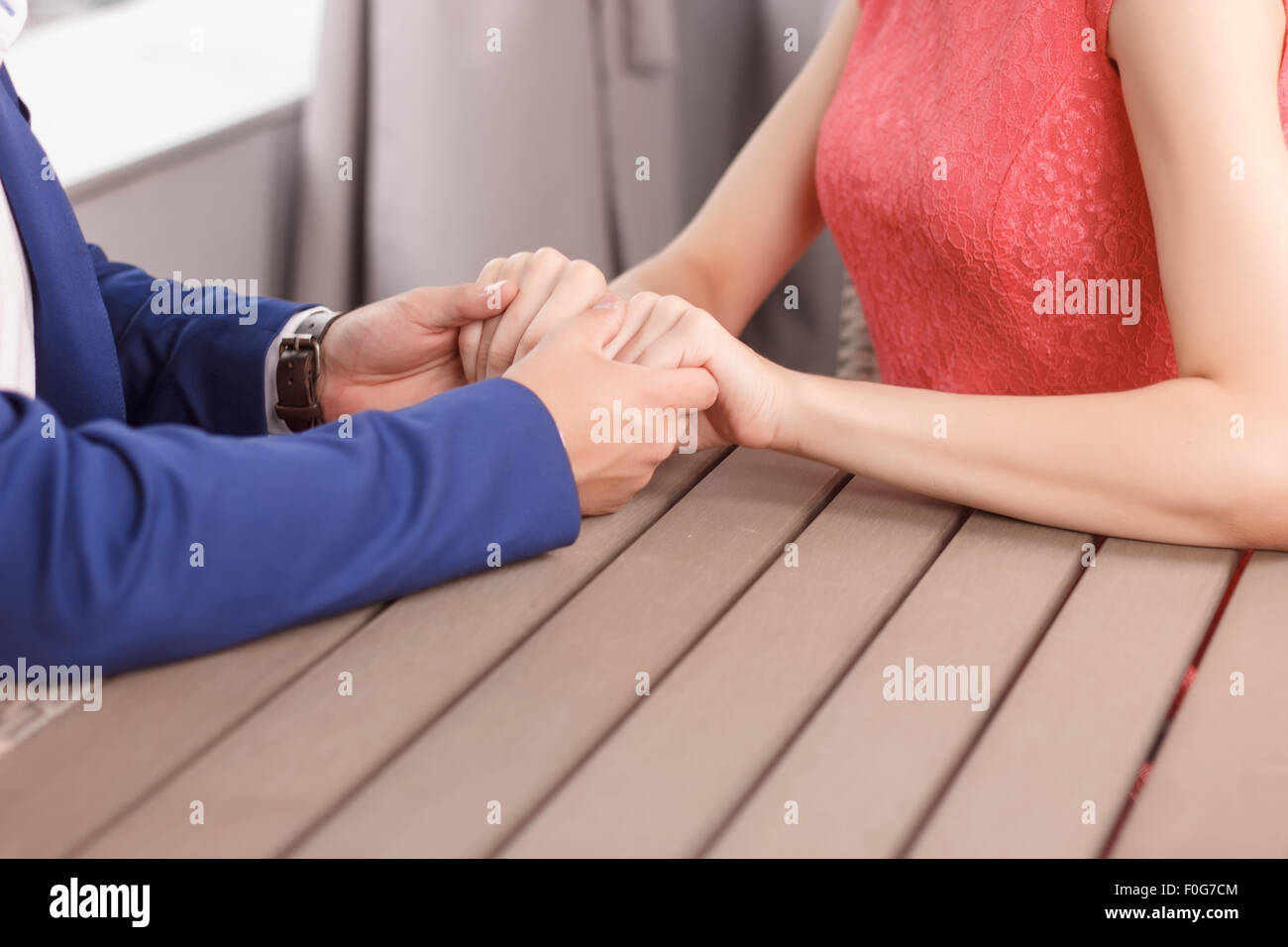 Man and woman hold hands hi-res stock photography and images - Alamy