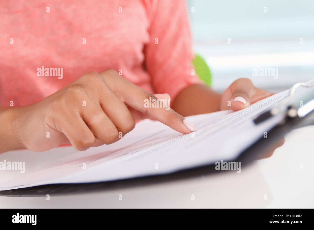 Close-up of woman holding folder with papers Stock Photo - Alamy