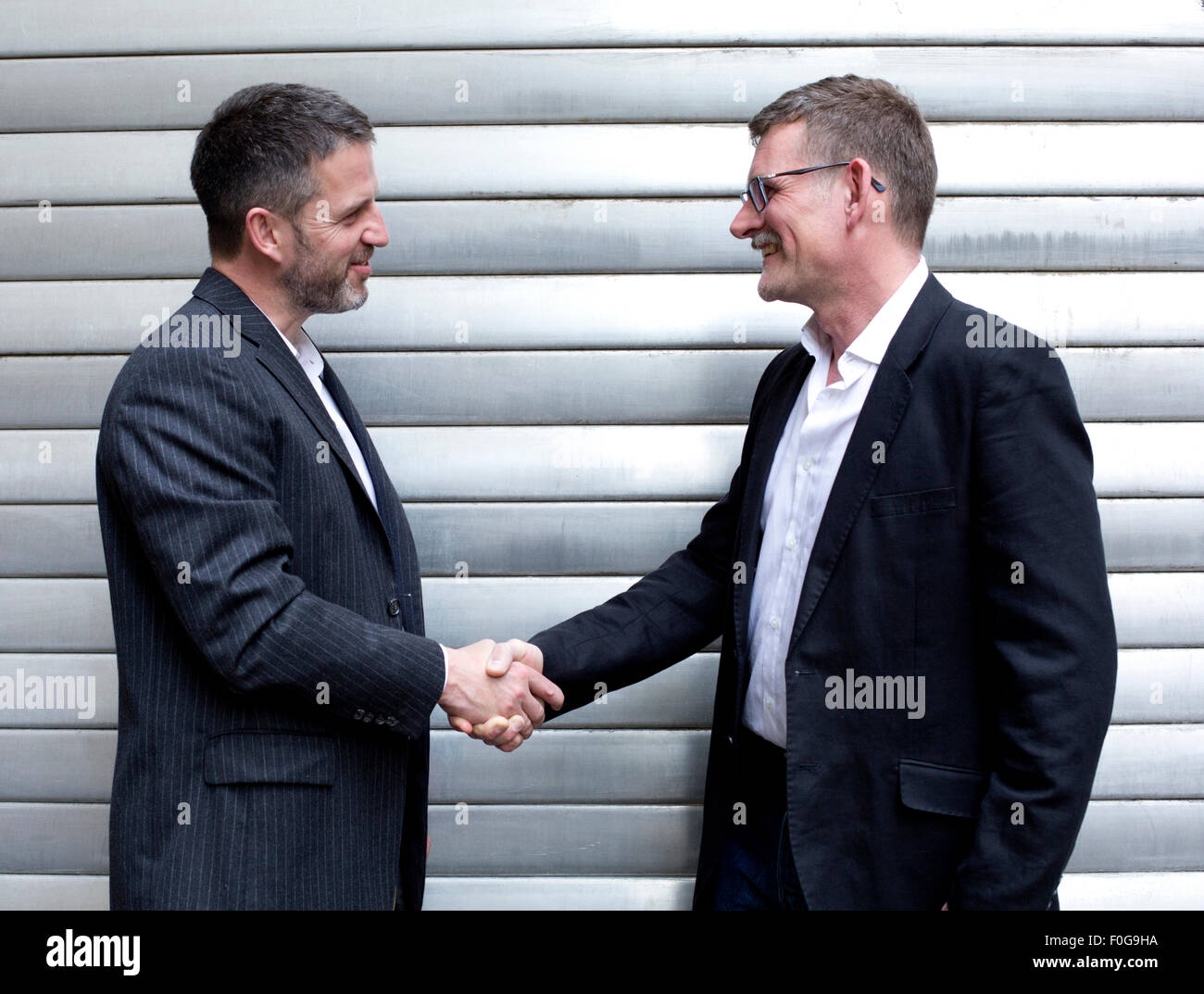 two businessmen shaking hands Stock Photo - Alamy