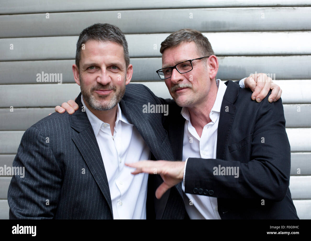 Two men hugging friends hi-res stock photography and images - Alamy