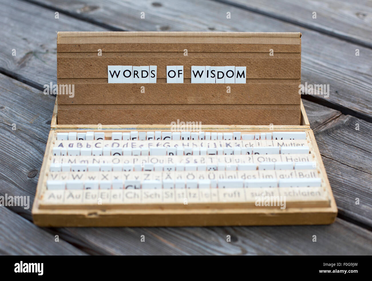 the words "words of wisdom" on an old school letter box Stock Photo - Alamy