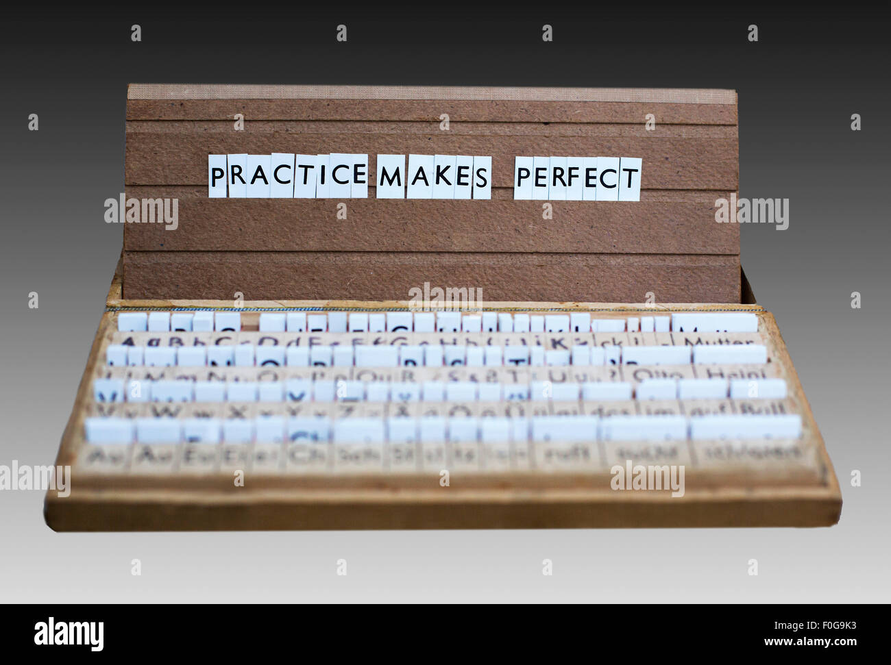 the words "practice makes perfect" on an old school letter box Stock ...