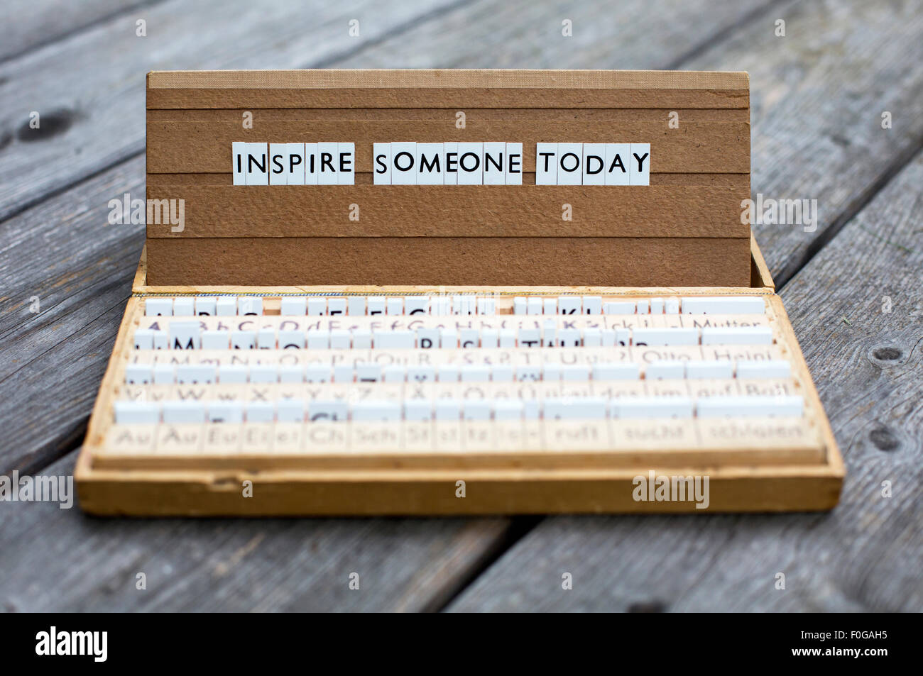 the words "inspire someone today" on an old school letter box Stock ...