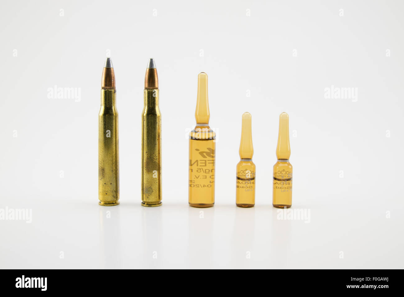 composition with vials and bullets on white background Stock Photo - Alamy