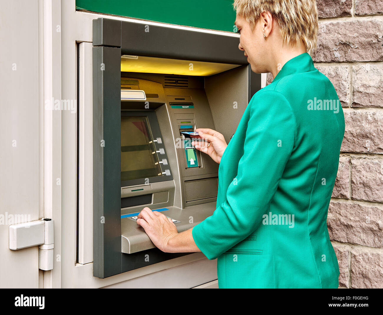 Business woman operates an ATM on the street Stock Photo - Alamy