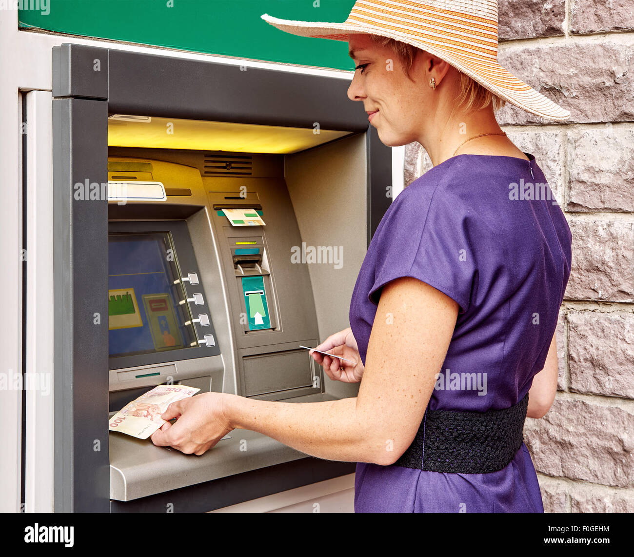 Woman atm smiling with cash hi-res stock photography and images - Alamy