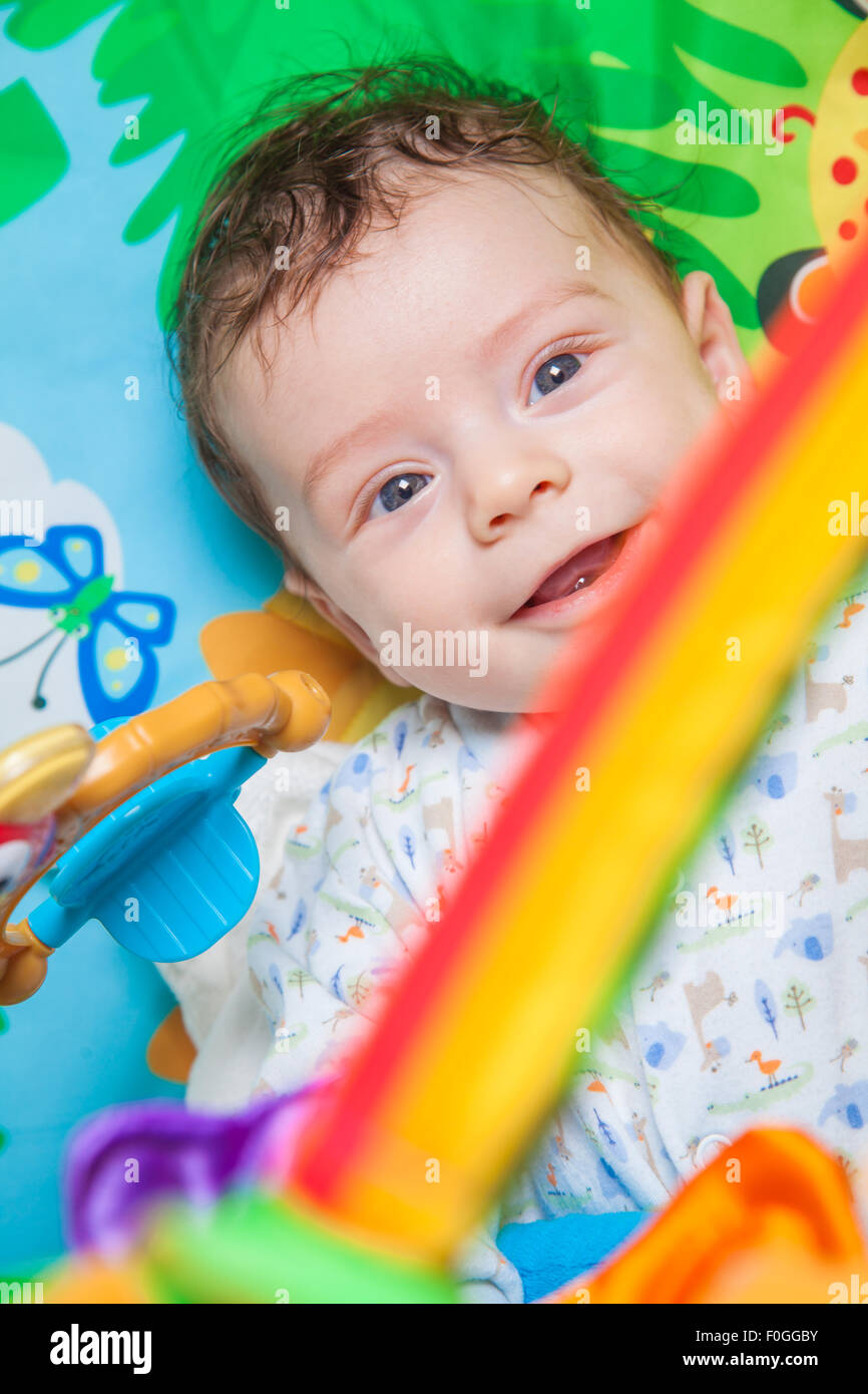 Innocent baby smiling playing toys hi-res stock photography and images - Alamy