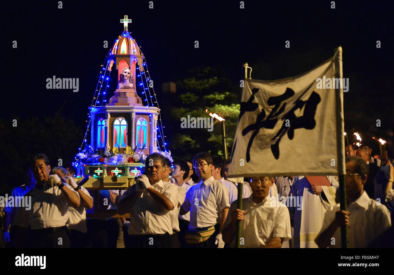 Nagasaki, Japan. 9th Aug, 2015. Worshippers start a torchlight ...