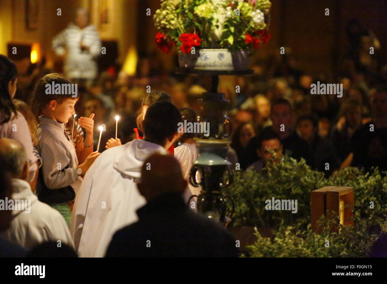 Burgundy, France. 15th Aug, 2015. Children carry burning candles, to ...