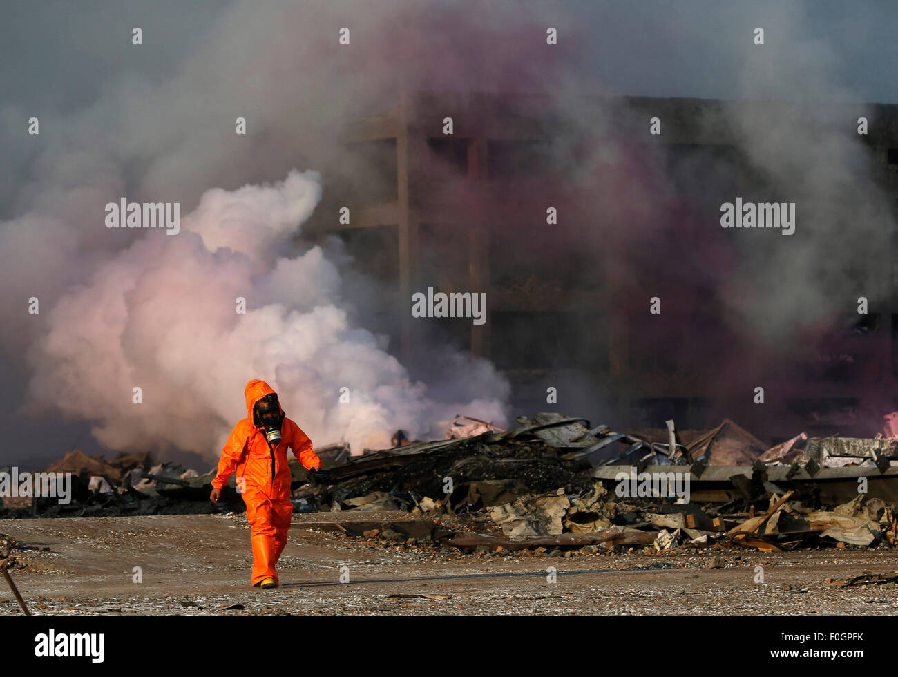 Beijing, China. 13th Aug, 2015. A firefighter works at the explosion ...