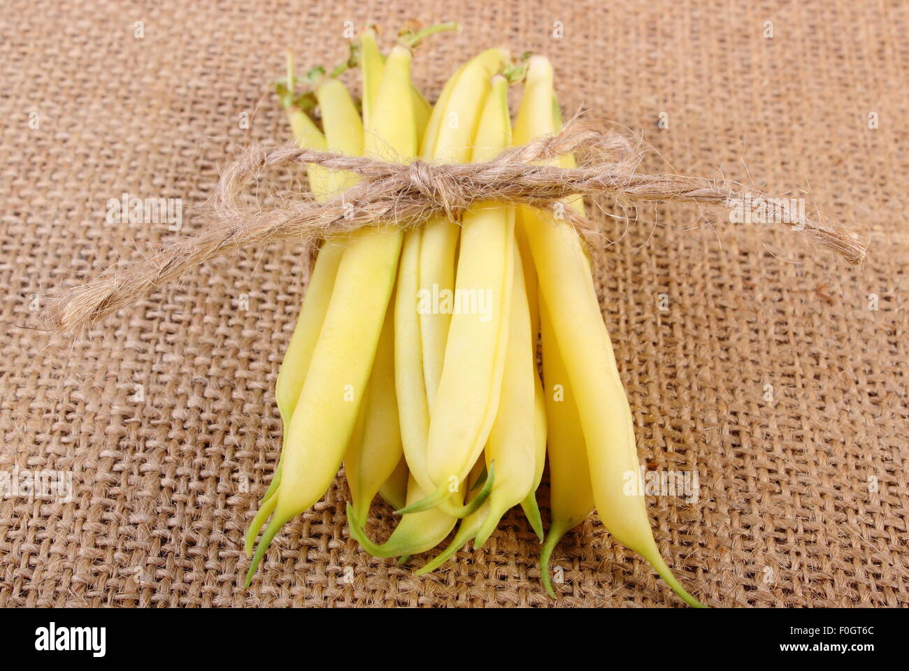 Stack of beans tied with string lying on jute canvas, healthy food and ...