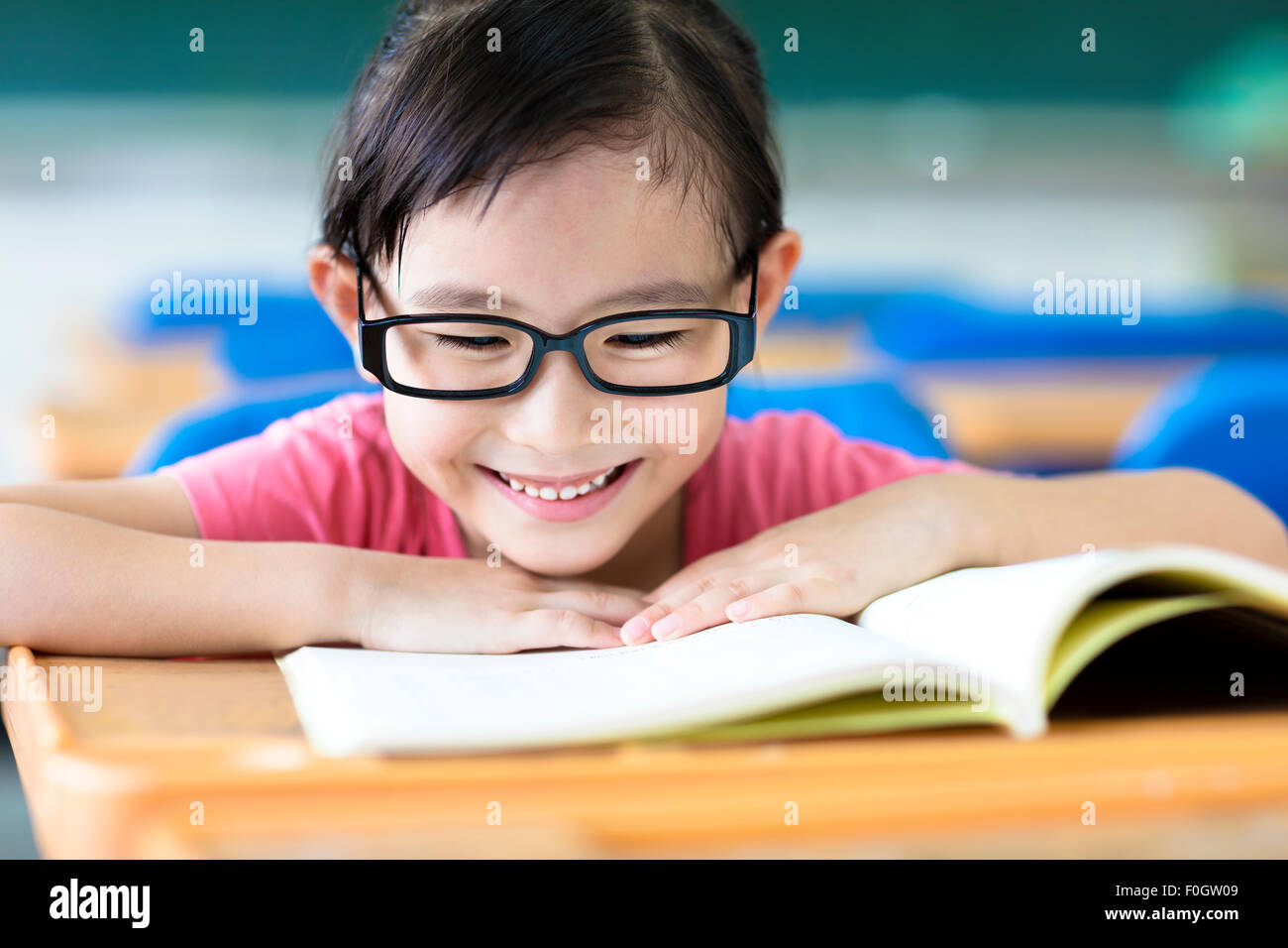 happy little girl studying in the classroom Stock Photo - Alamy
