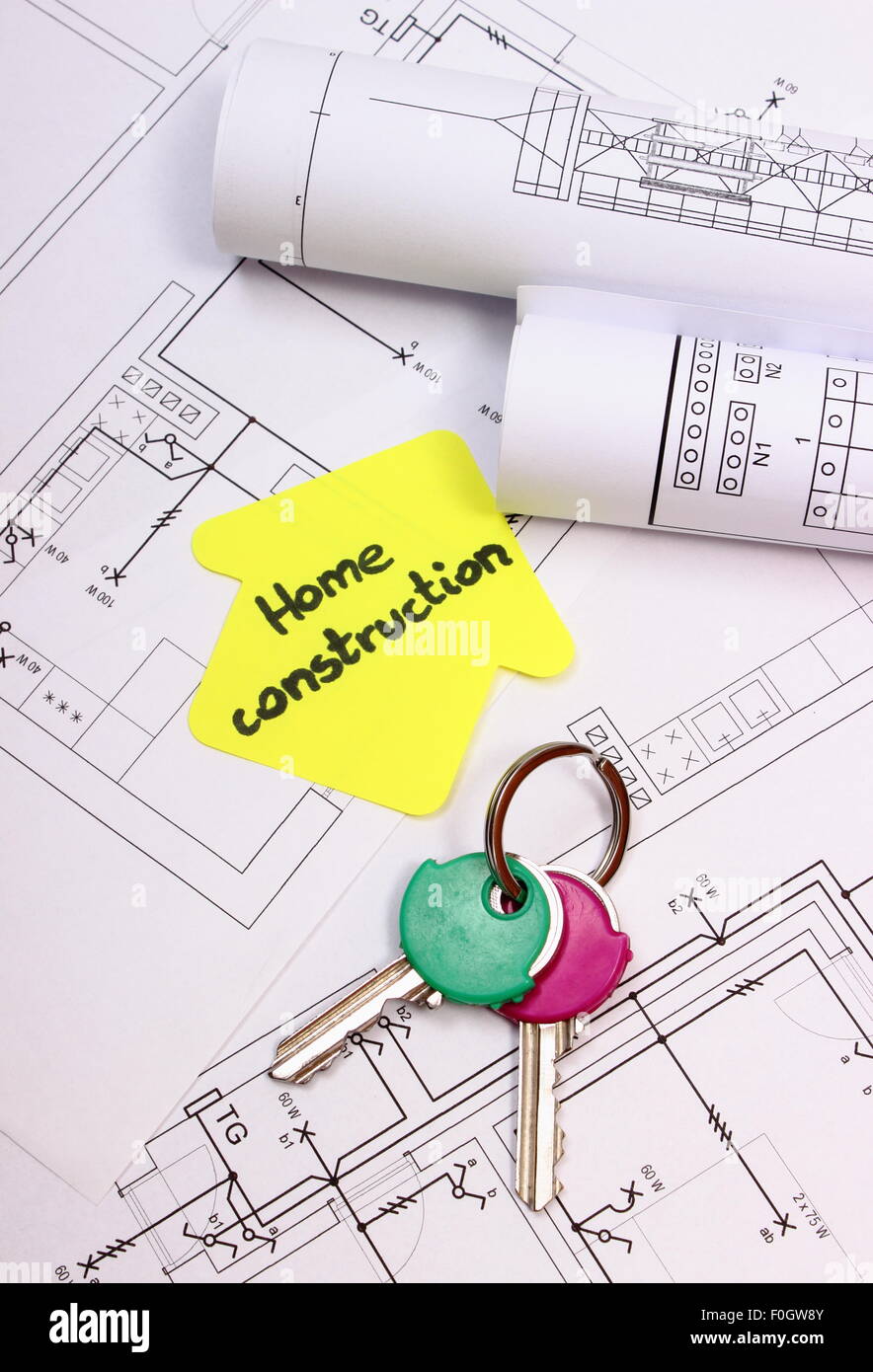 Home keys, house of yellow paper with text home construction and rolls ...