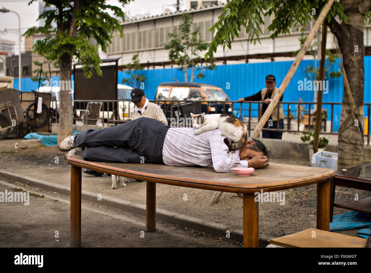 May 08, 2012 - Osaka, Japan - Man sleeps on table. City of Ghosts - A ...