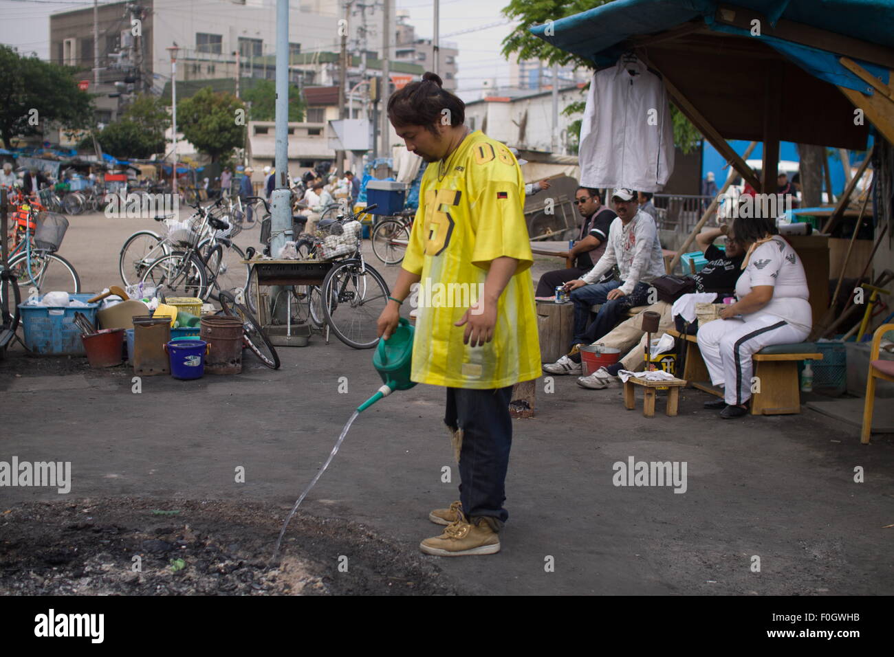 May 8, 2012 - Osaka, Japan - Man puts out fire. City of Ghosts - A life ...