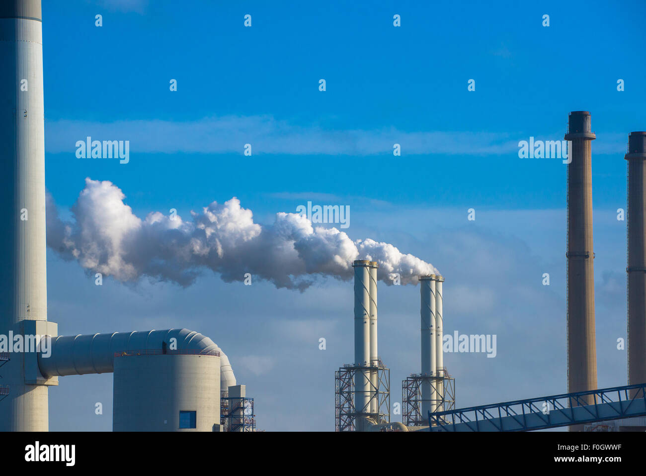chimneys with smoke and blue sky Stock Photo - Alamy