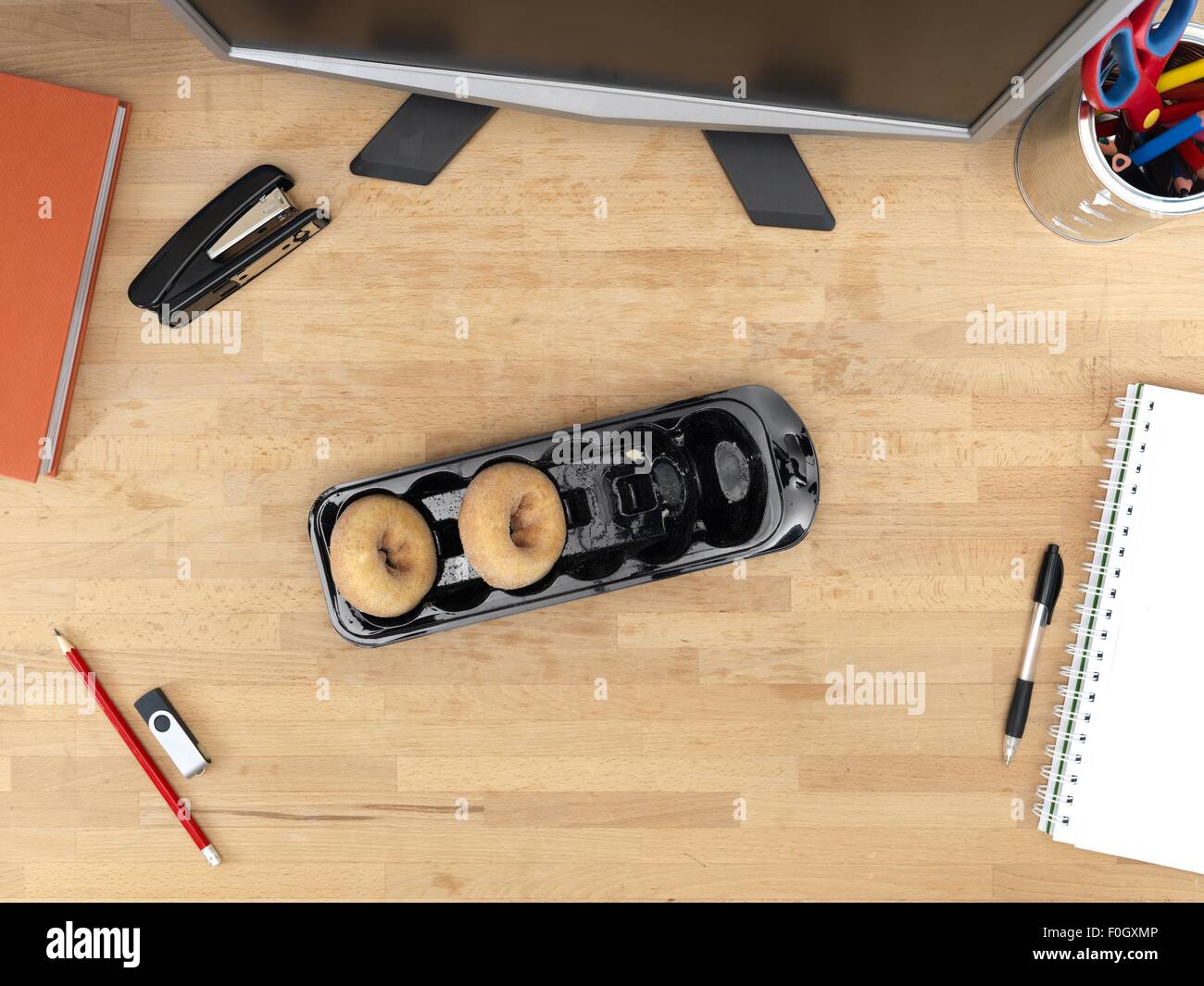 A conceptual lifestyle image of doughnuts on a work desk Stock Photo ...