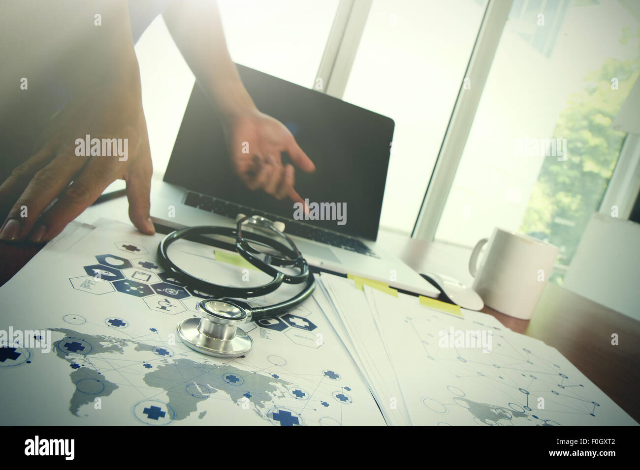 Doctor working with laptop computer in medical workspace office and ...