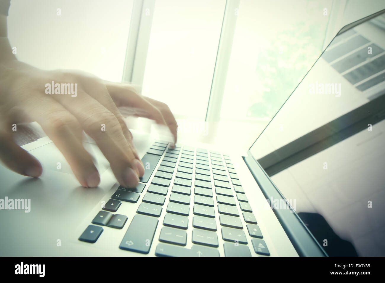Close up of business man hand working on blank screen laptop computer ...