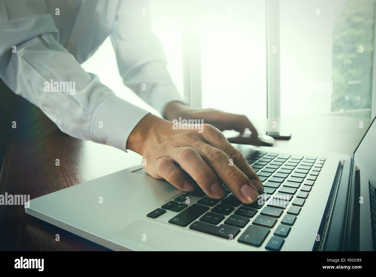 Close up of business man hand working on blank screen laptop computer ...
