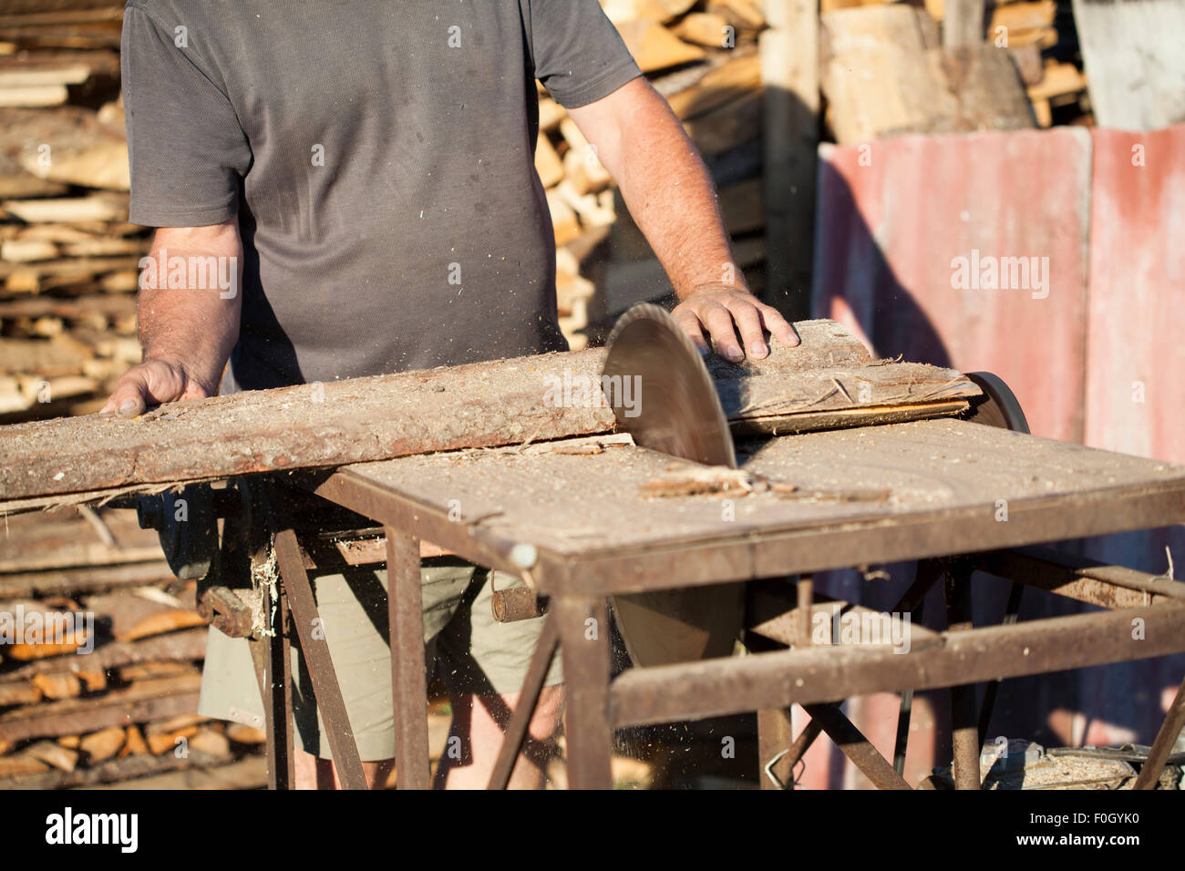 Lumberman working on circular saw Stock Photo - Alamy