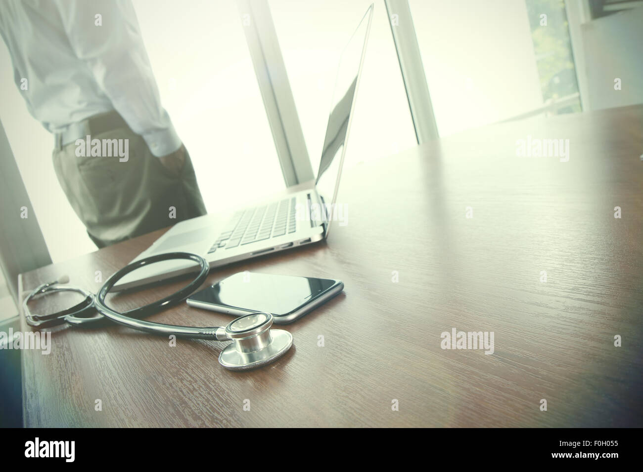 Doctor working at workspace with laptop computer in medical workspace ...