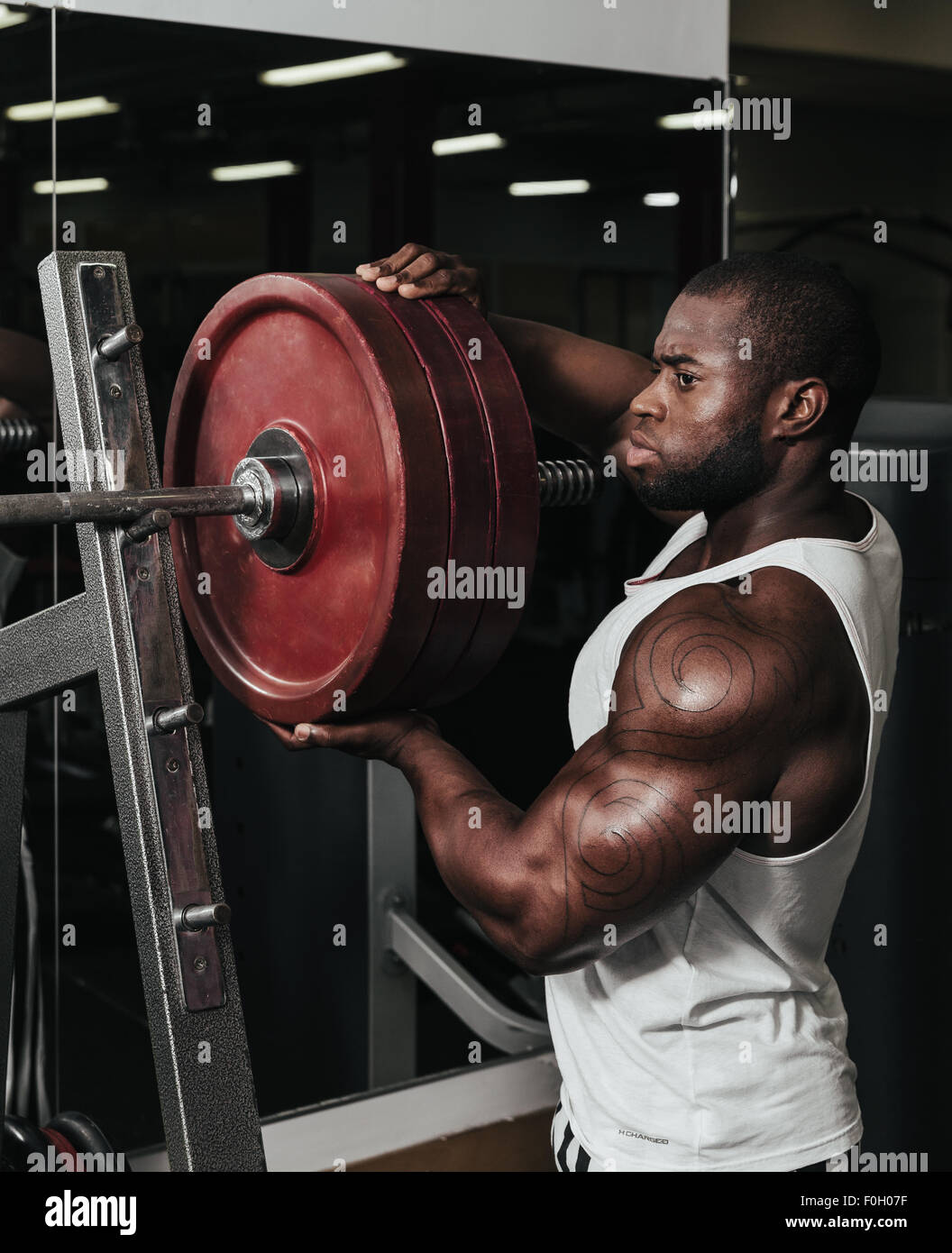 Weight training African doing bodybuilding in gym Stock Photo - Alamy