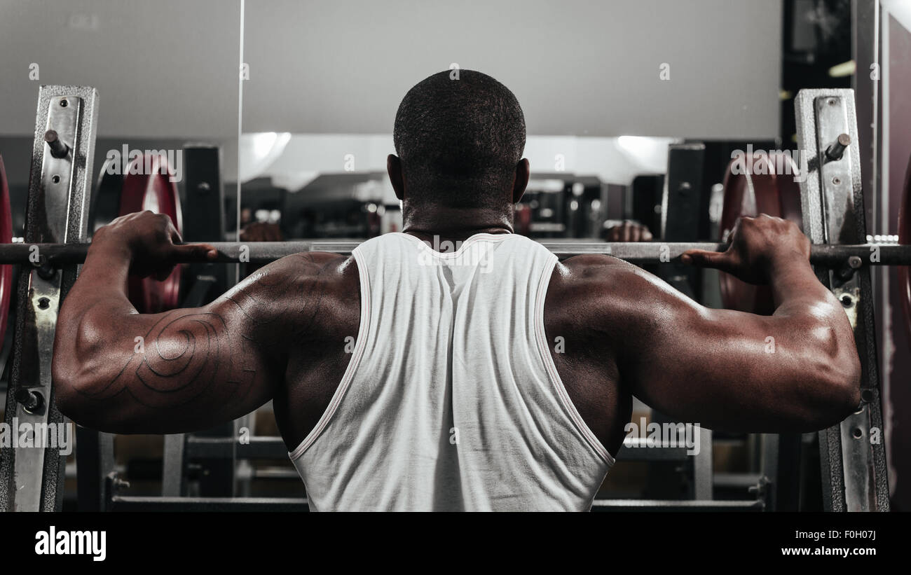 Weight training African doing bodybuilding in gym Stock Photo - Alamy