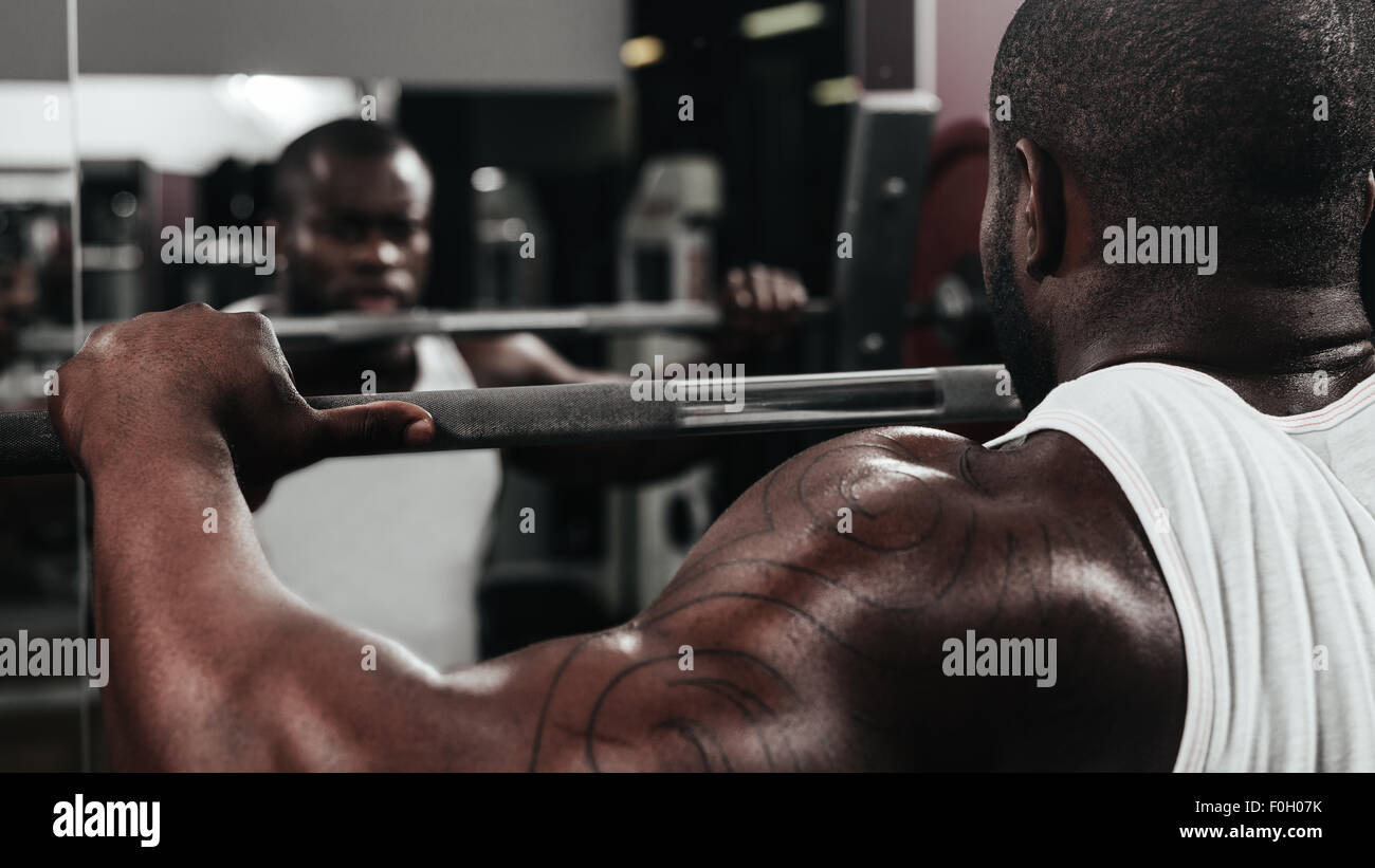 Weight training African doing bodybuilding in gym Stock Photo - Alamy