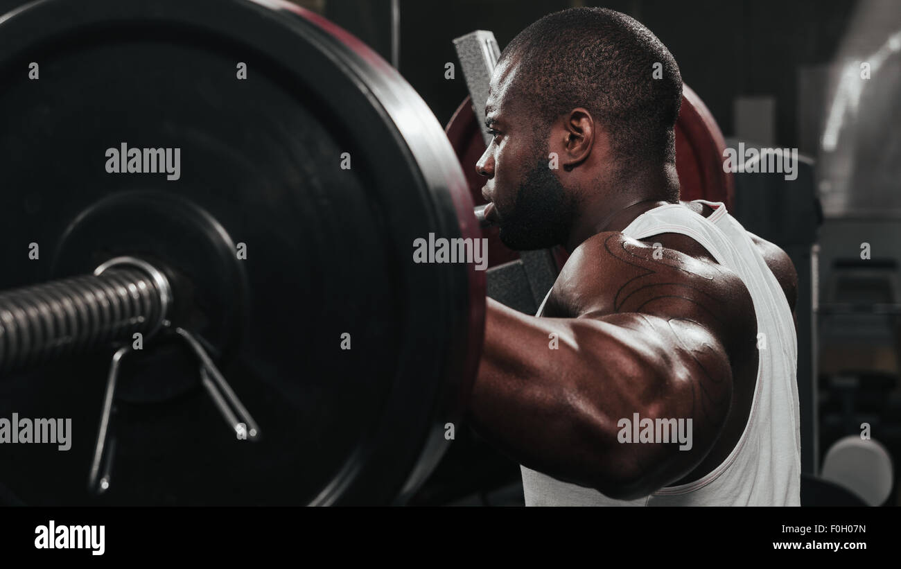 Weight training African doing bodybuilding in gym Stock Photo - Alamy